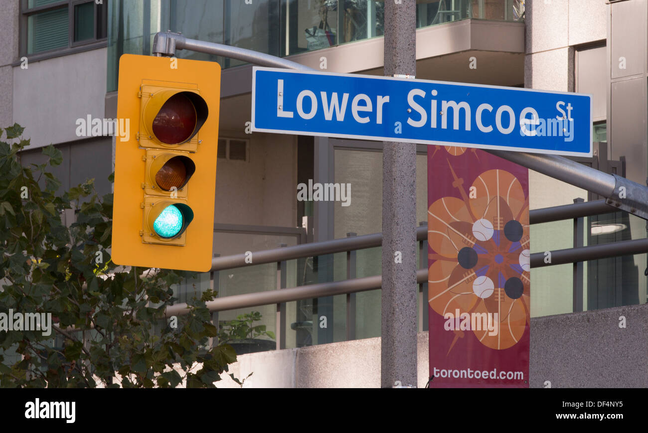 Lower Simcoe St. street sign with traffic light in downtown Toronto ...