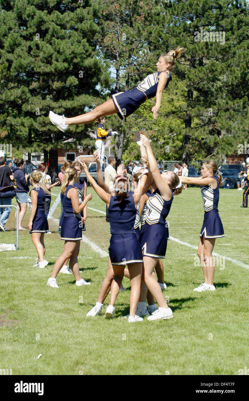 Cheerleaders performing during football game Stock Photo - Alamy