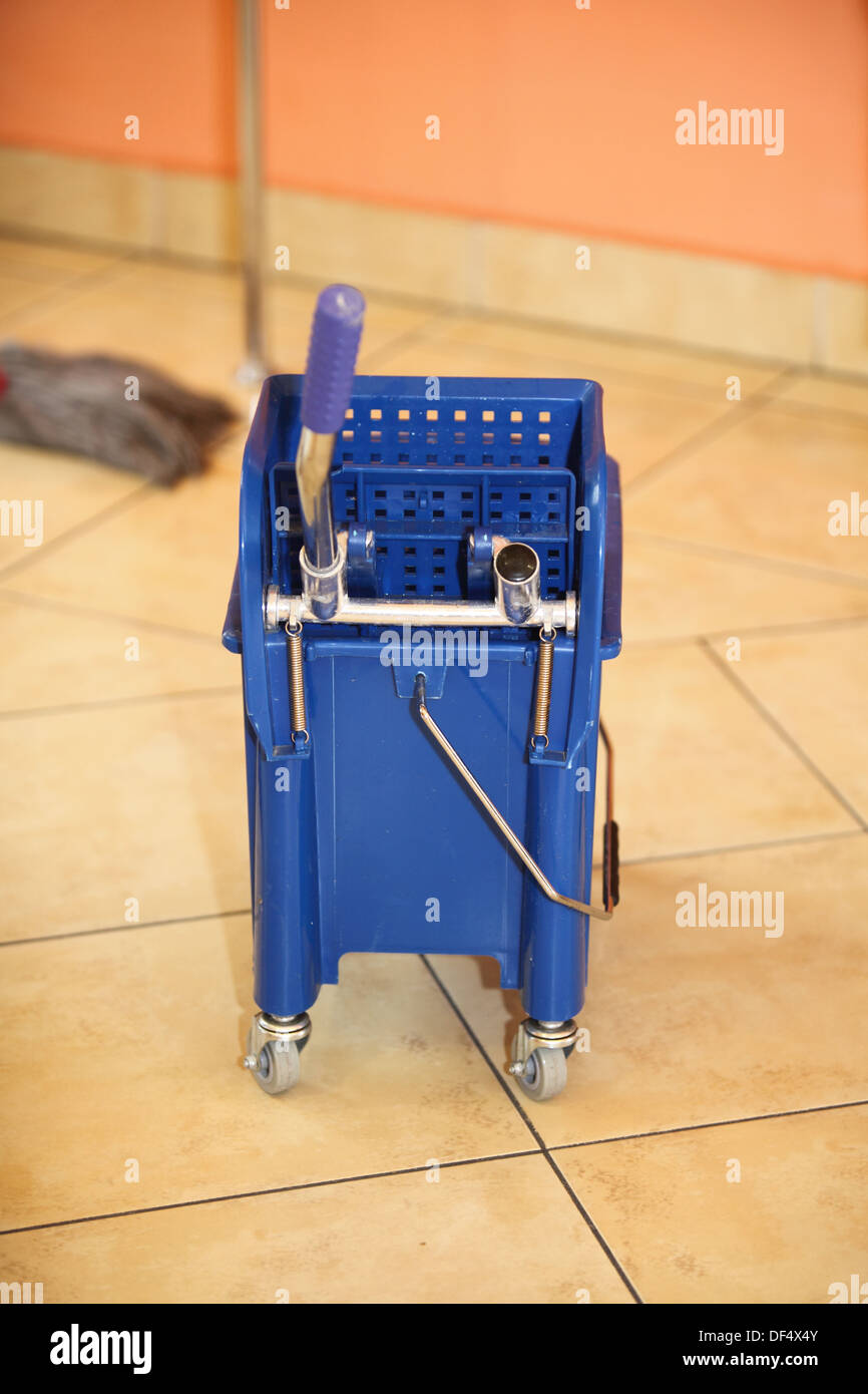 Blue mop bucket on the tiled floor Stock Photo - Alamy