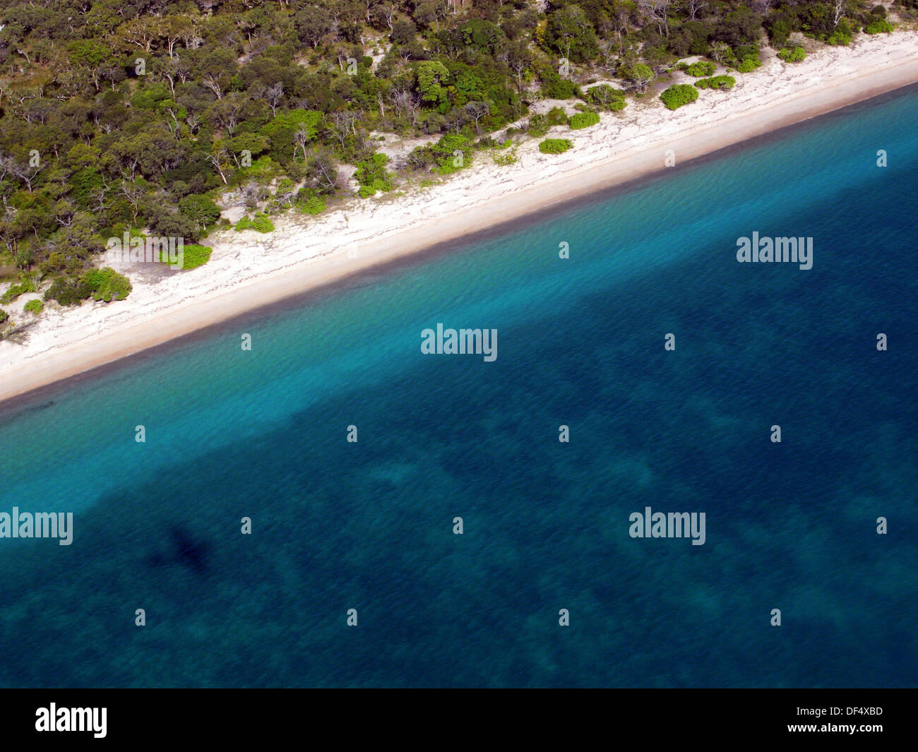 Remote beach on the western coast of Badu Island, with plane shadow ...
