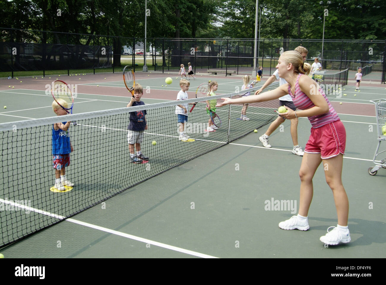 4 And 5 Year Old Children Take Group Tennis Lessons Taught By College 4-and-5-year-old-children-take-group-tennis-lessons-taught-by-college