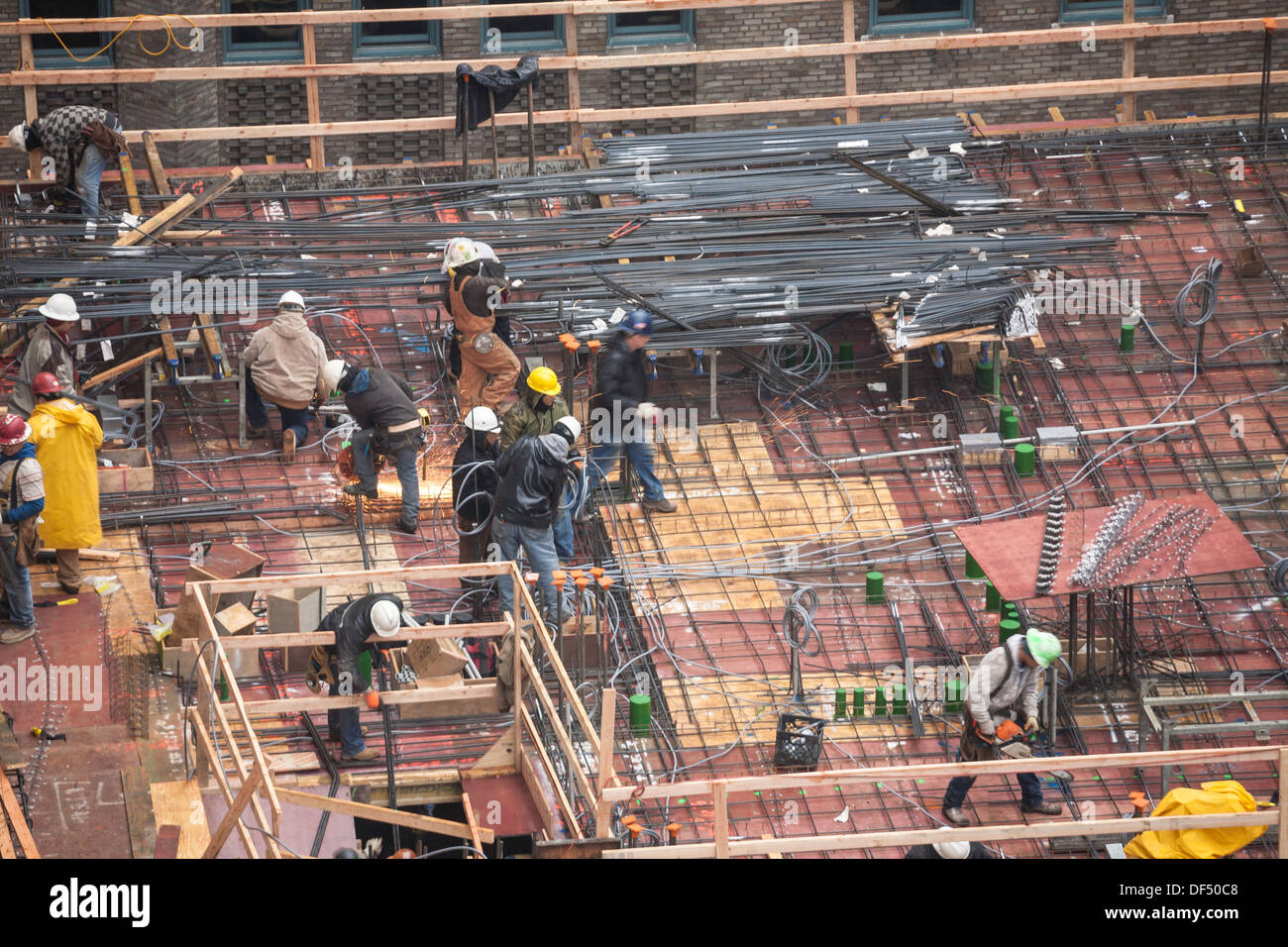 High-rise Building Construction Site with Tradesmen Stock Photo - Alamy