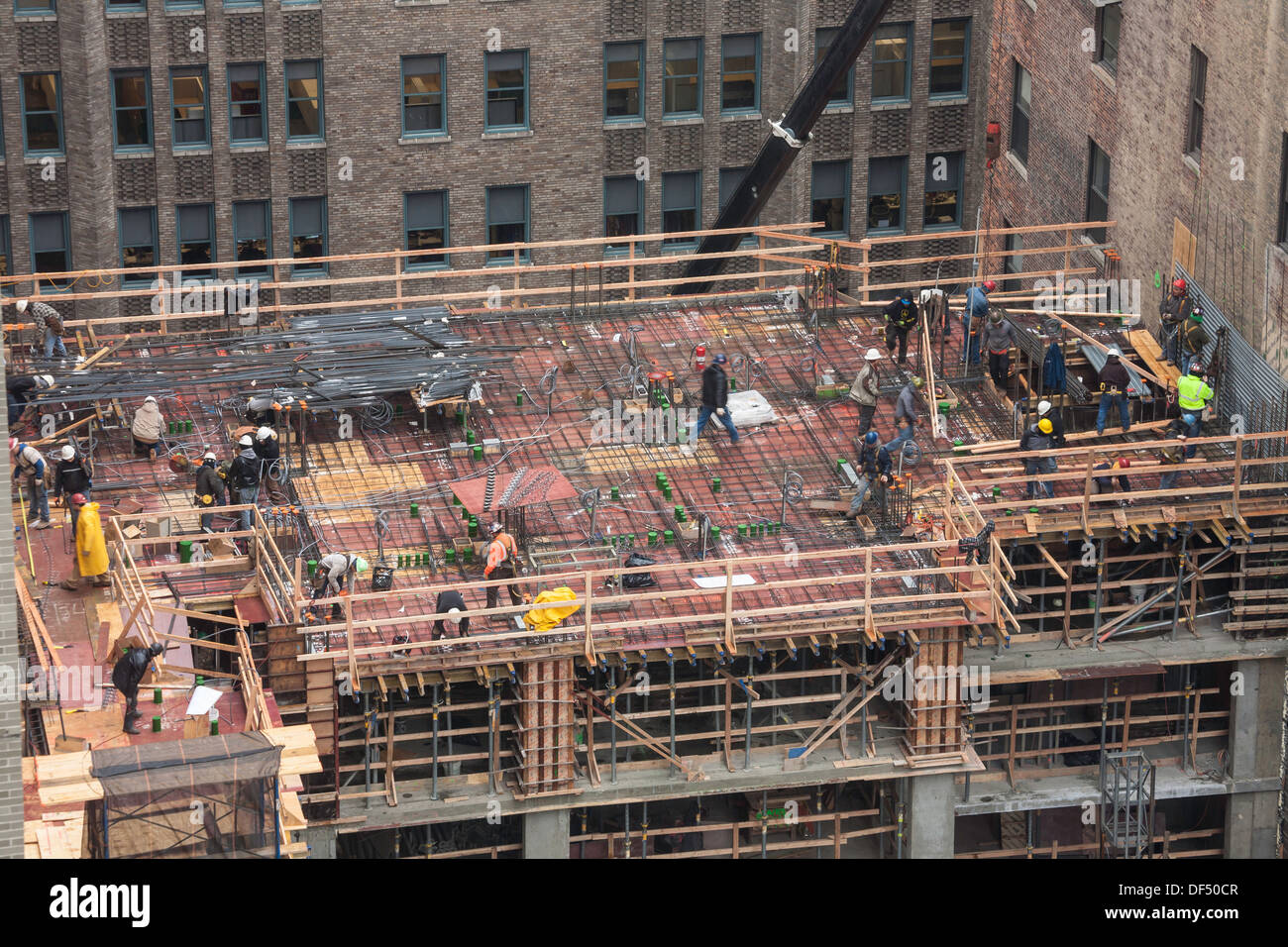 High-rise Building Construction Site with Tradesmen Stock Photo - Alamy