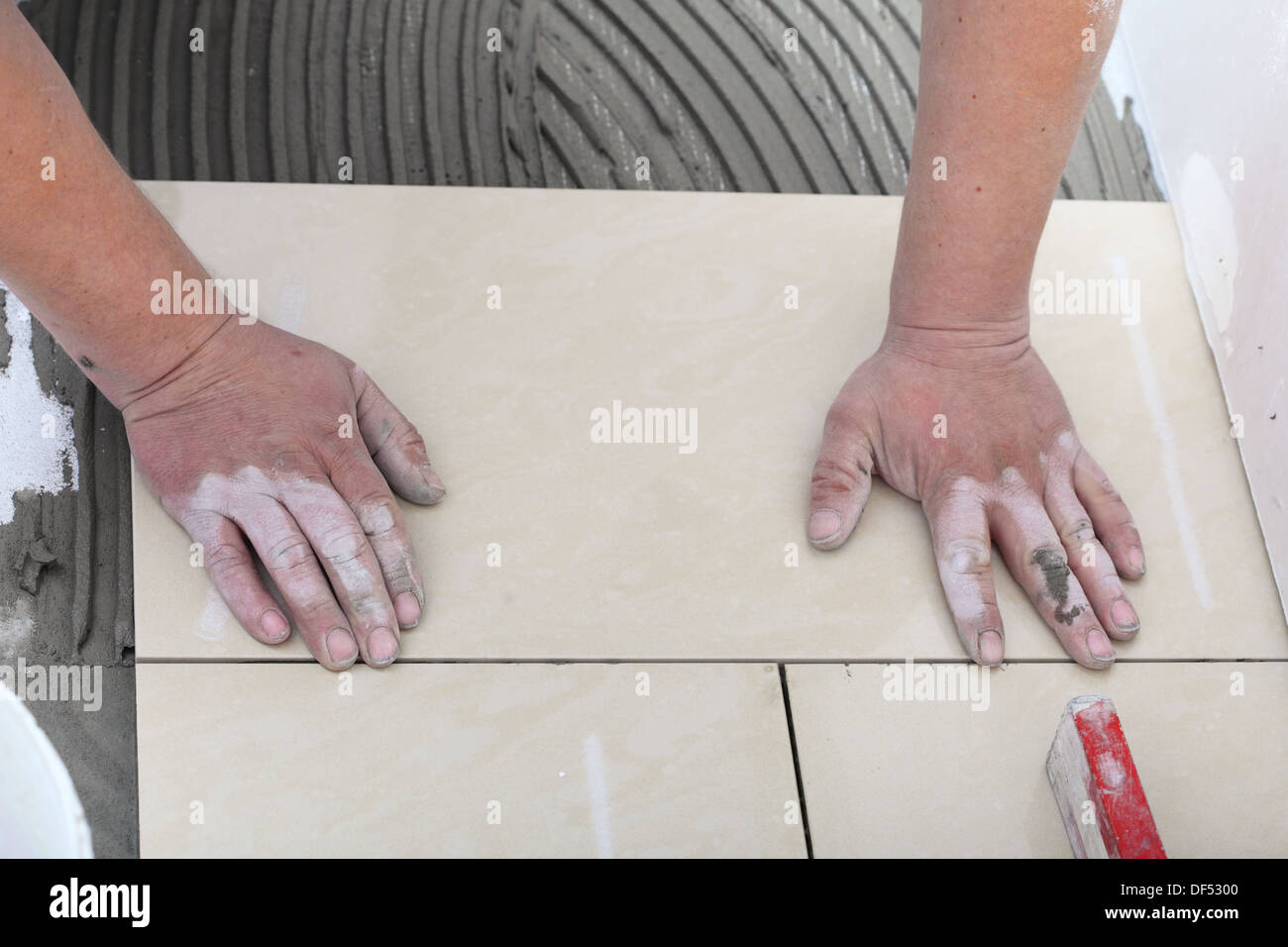 Home improvement, renovation - construction worker tiler is tiling ...