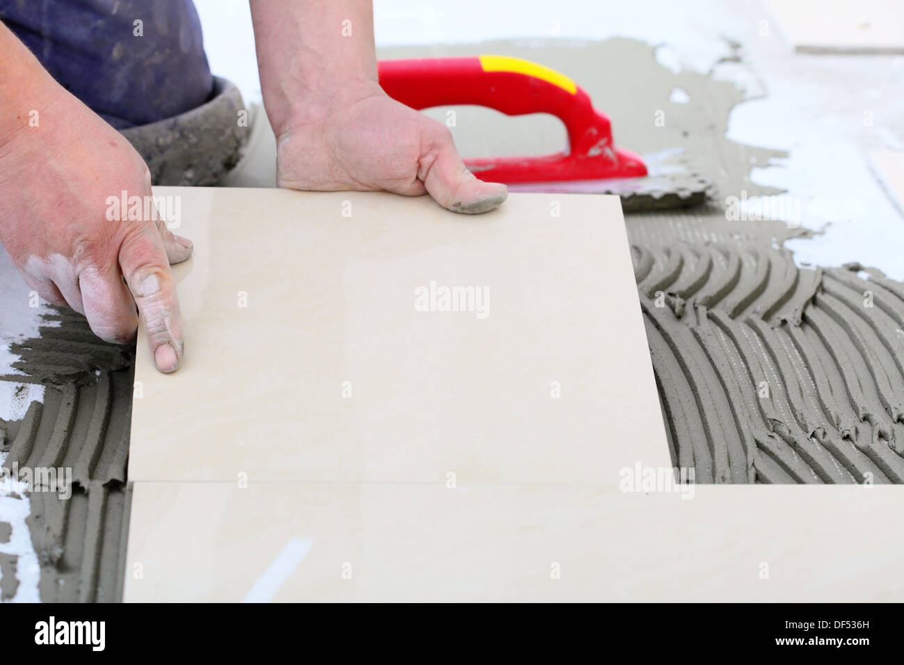 Home improvement, renovation - construction worker tiler is tiling ...