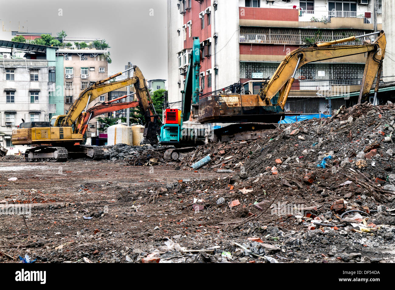 Construction site with rubble and trucks demolishing Stock Photo - Alamy