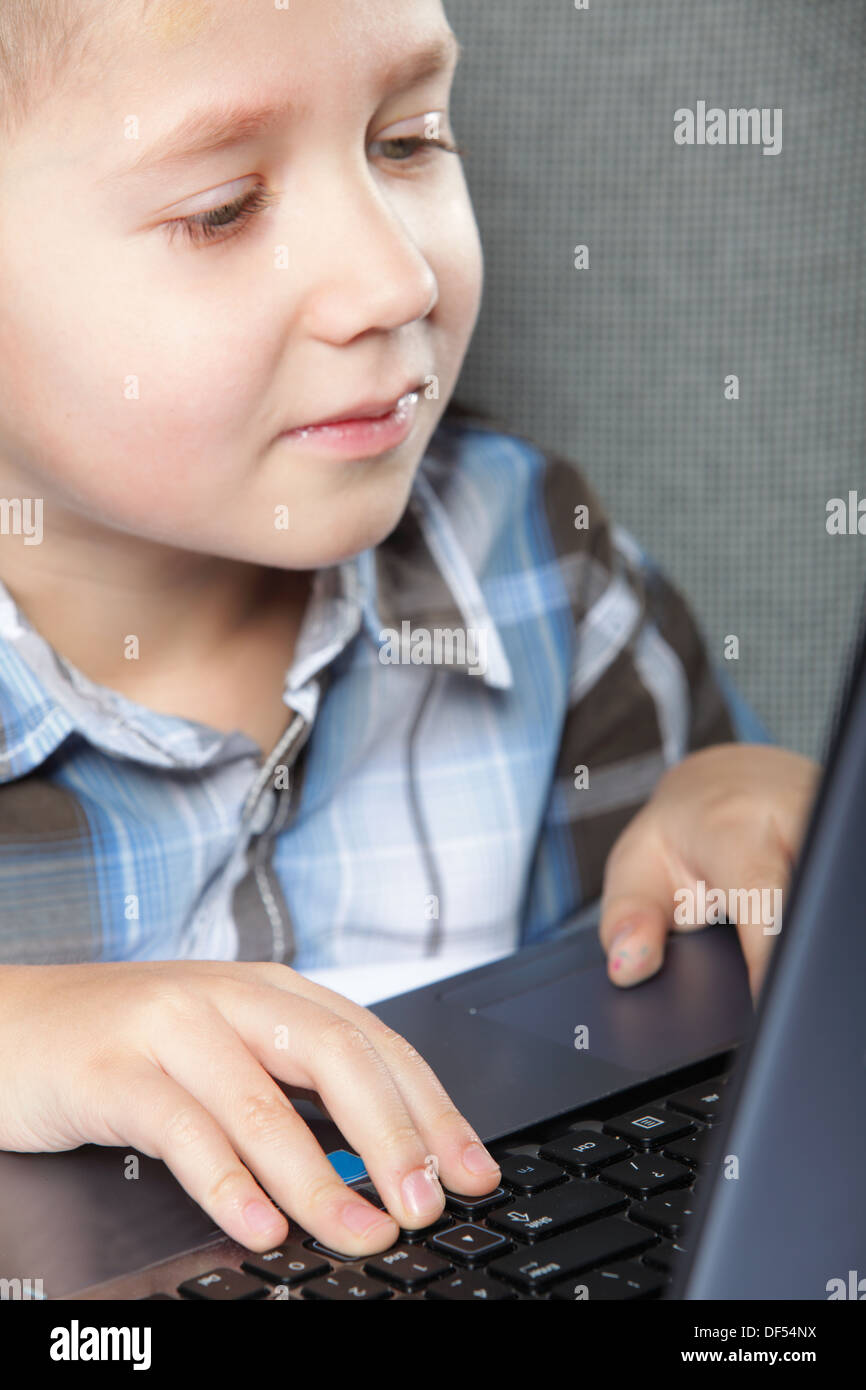 Computer addiction child boy with laptop notebook black background ...