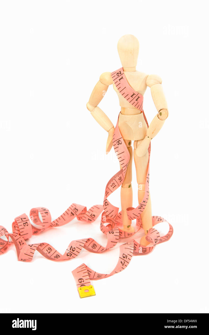 wooden doll with measuring tape Stock Photo - Alamy