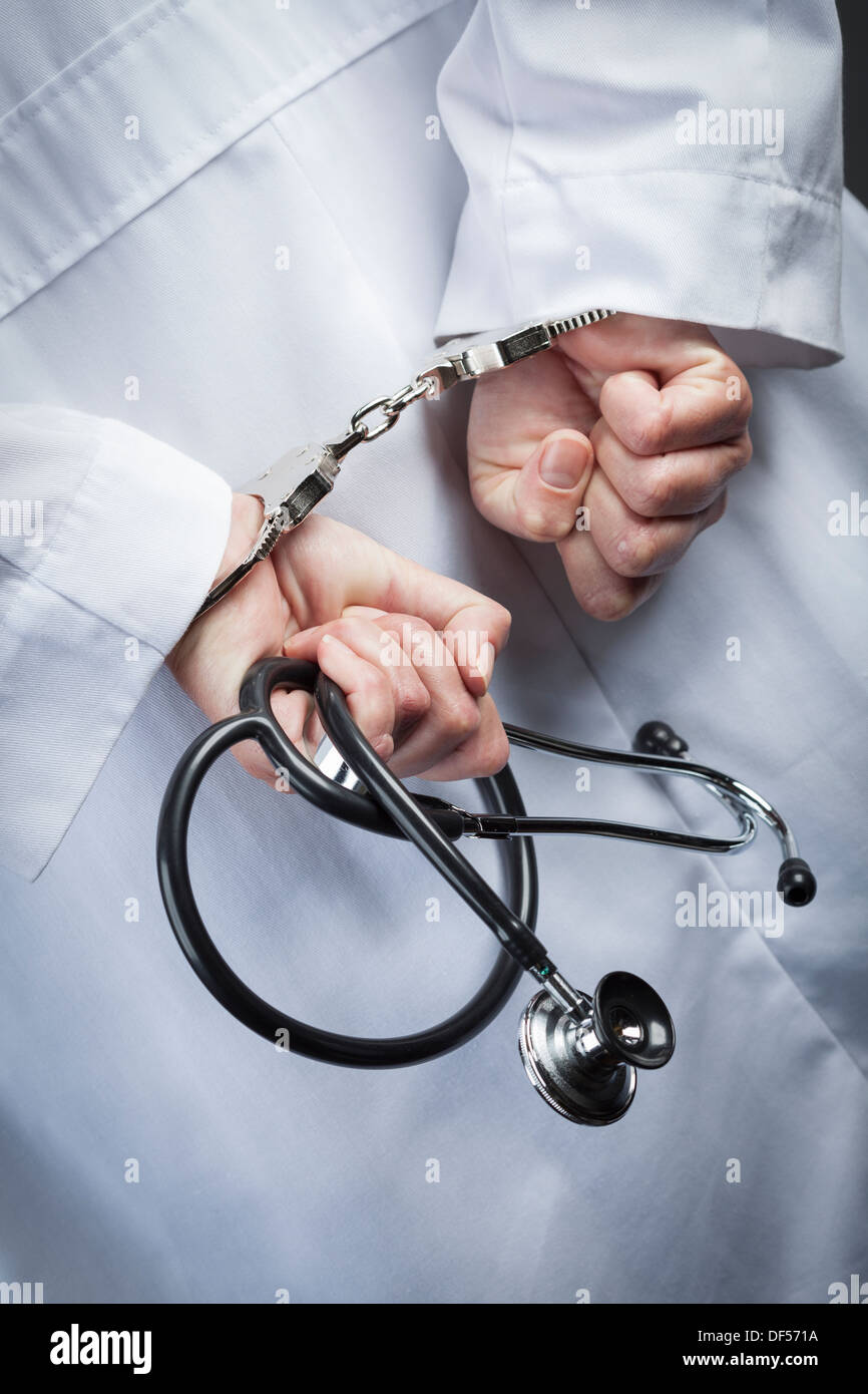 Female Doctor or Nurse In Handcuffs and Lab Coat Holding Stethoscope ...