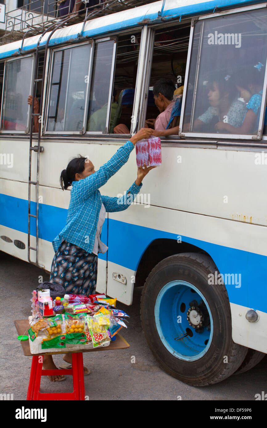 A vendor makes a sale at a bus station in Mandalay, Burma Stock Photo ...