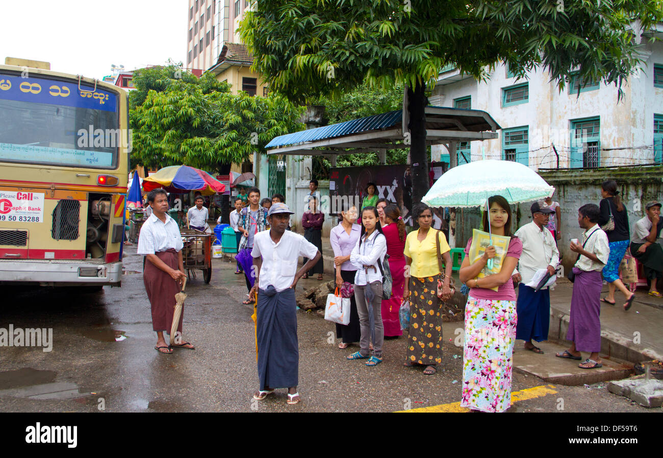 People wait at a bus stop in Yangon, Burma Stock Photo - Alamy
