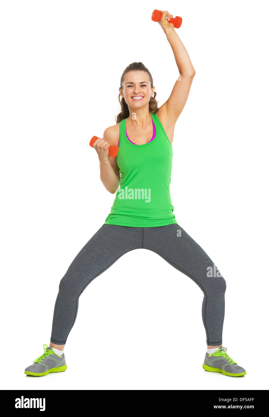 Full length portrait of smiling healthy young woman making exercise ...