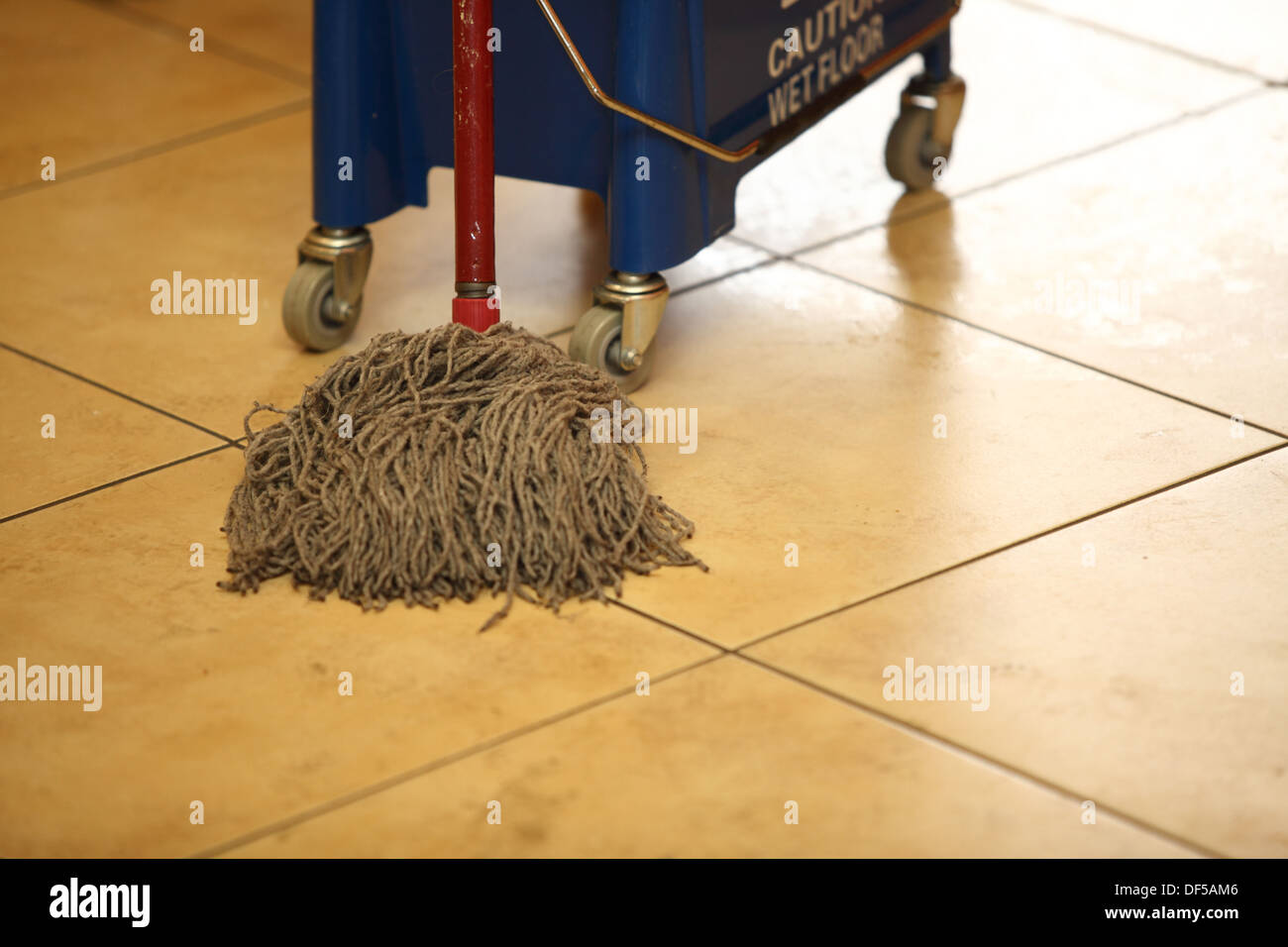 cleaning the floor with a old mop, mopping Stock Photo - Alamy