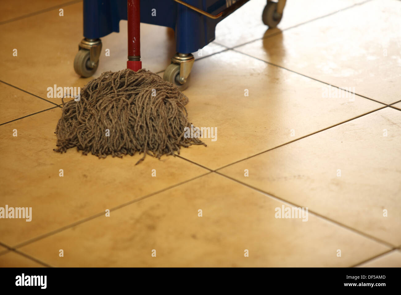cleaning the floor with a old mop, mopping Stock Photo - Alamy