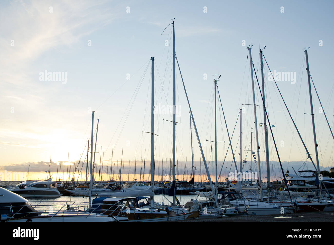 Crowd of sailing boats in harbor at evening Stock Photo - Alamy