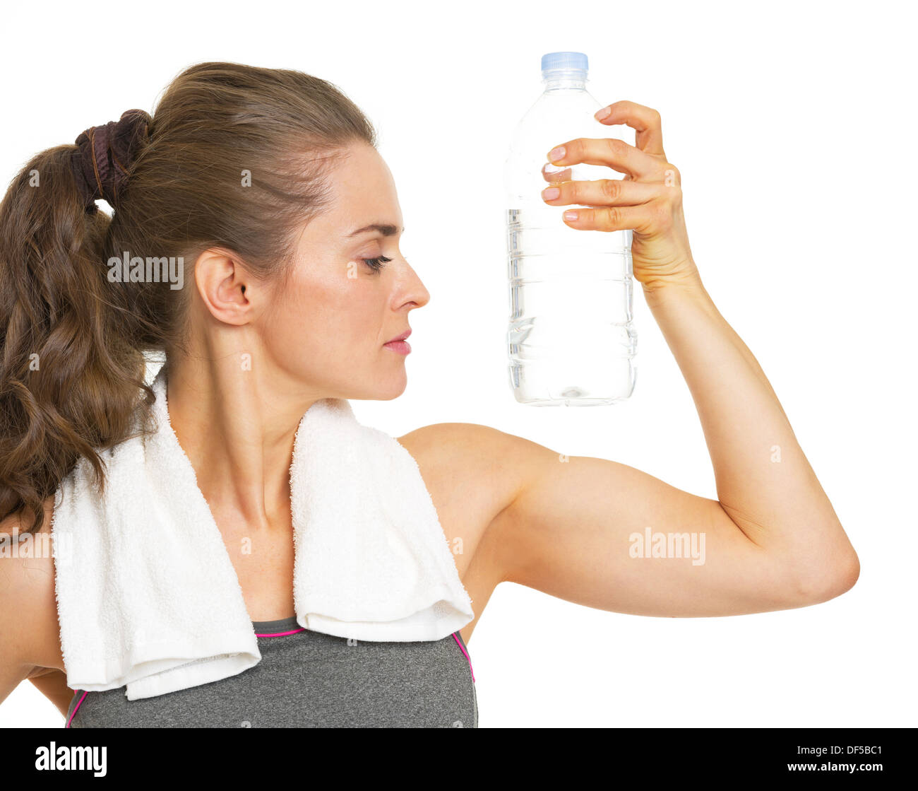 Fitness young woman with bottle of water showing biceps Stock Photo - Alamy