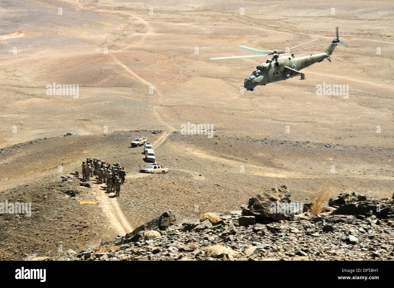 An Afghan air force Mi-35 helicopter gunship flies over a group of ...