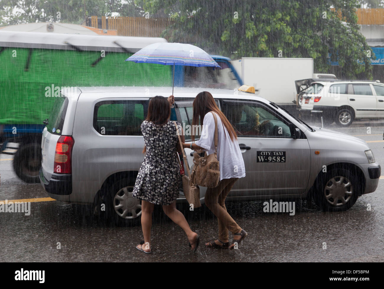 People walk in the rain in Yangon, Burma Stock Photo - Alamy