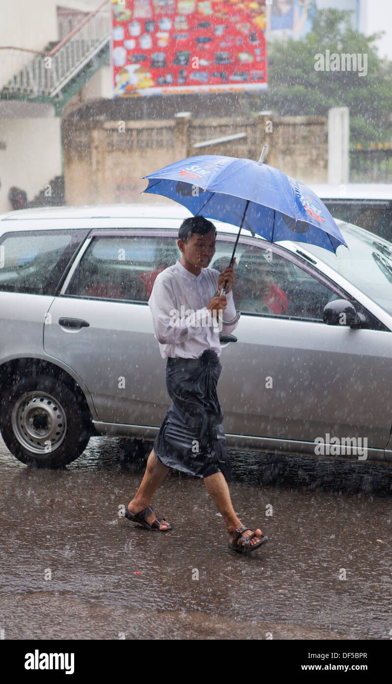 A man walks in the rain in Yangon, Burma Stock Photo - Alamy