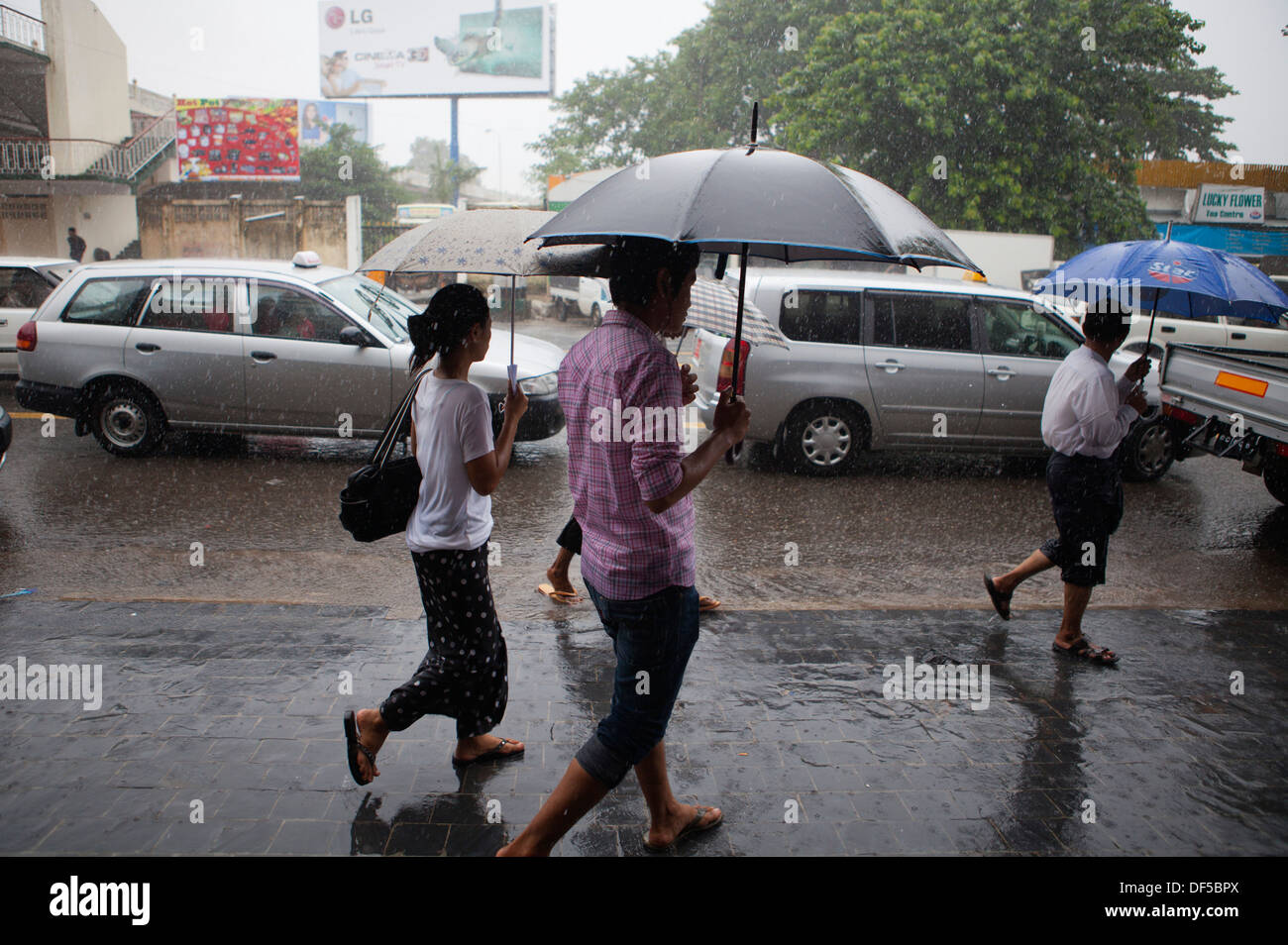 People walk in the rain in Yangon, Burma Stock Photo - Alamy