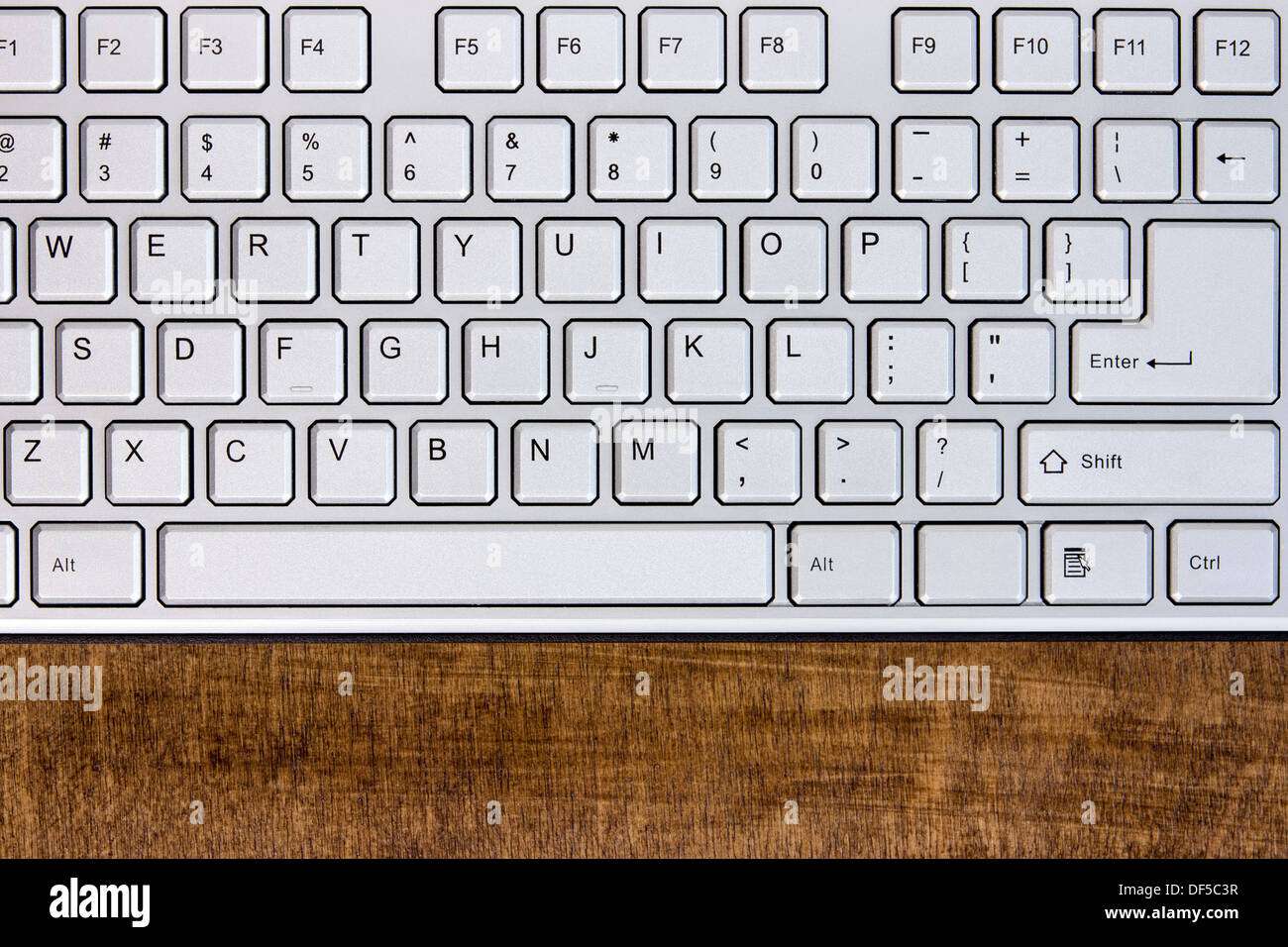 Modern computer keyboard on the wooden desk Stock Photo - Alamy