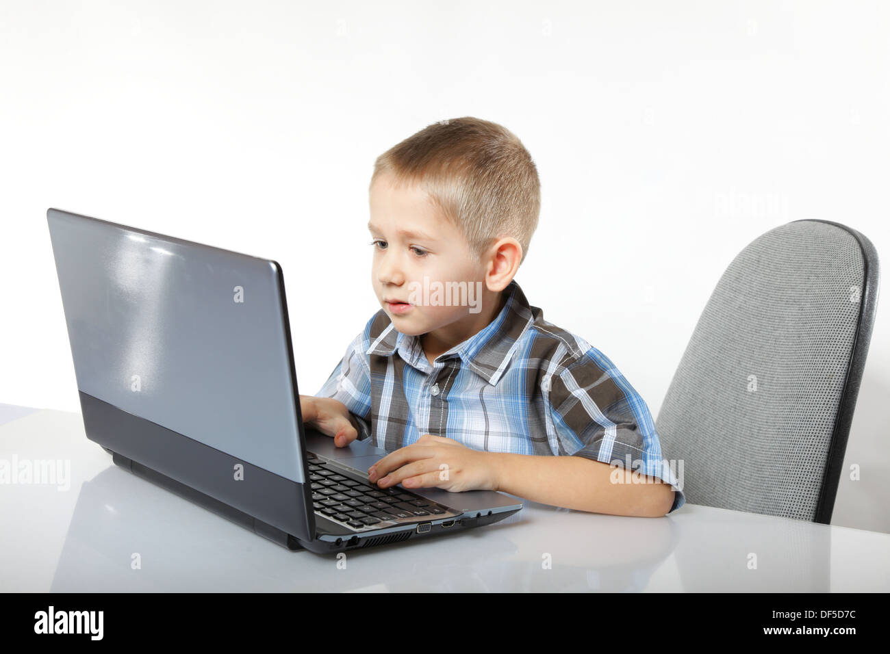 Computer addiction child boy with laptop notebook white background ...