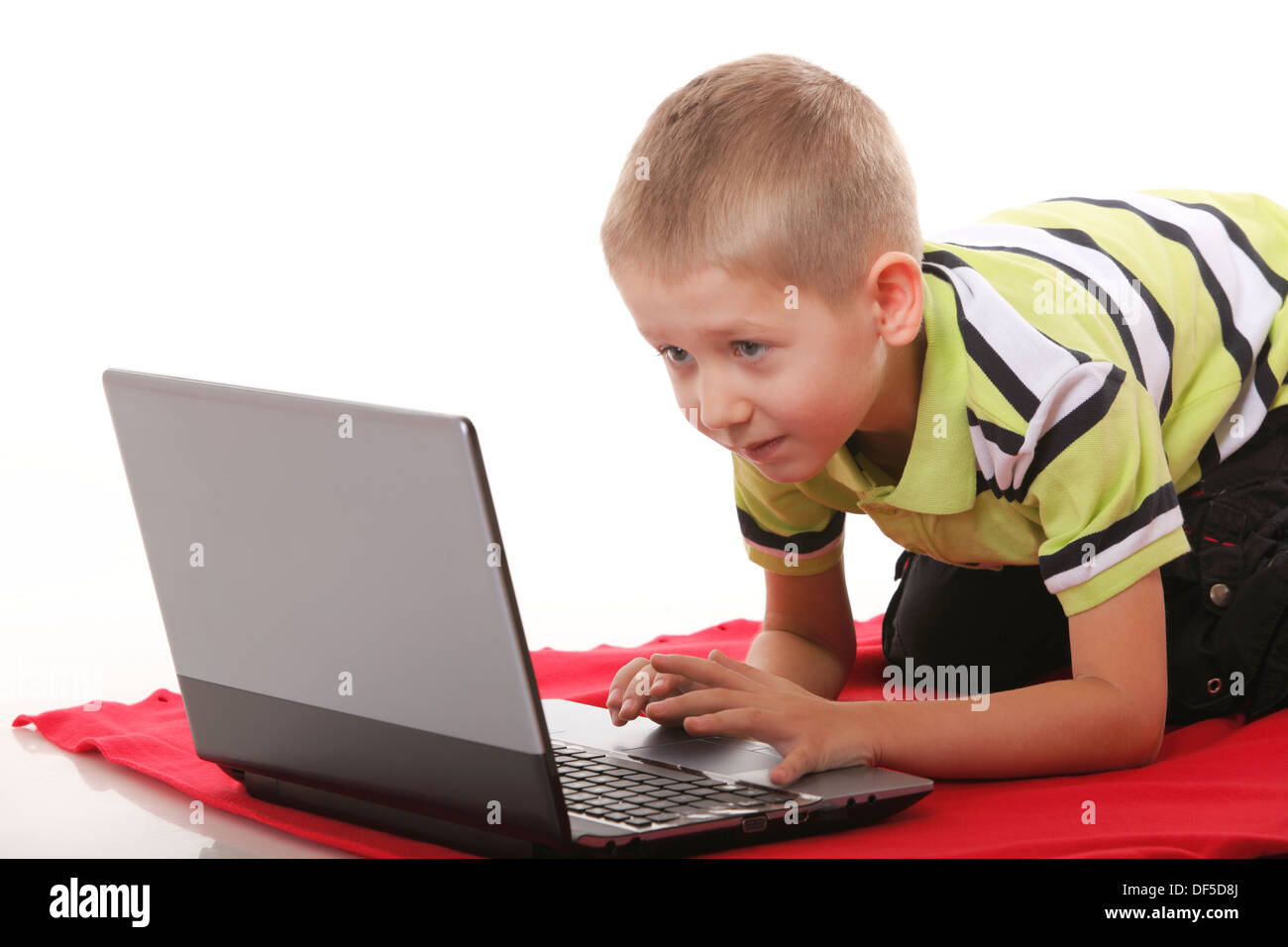 Computer addiction emotional child boy with laptop notebook playing ...