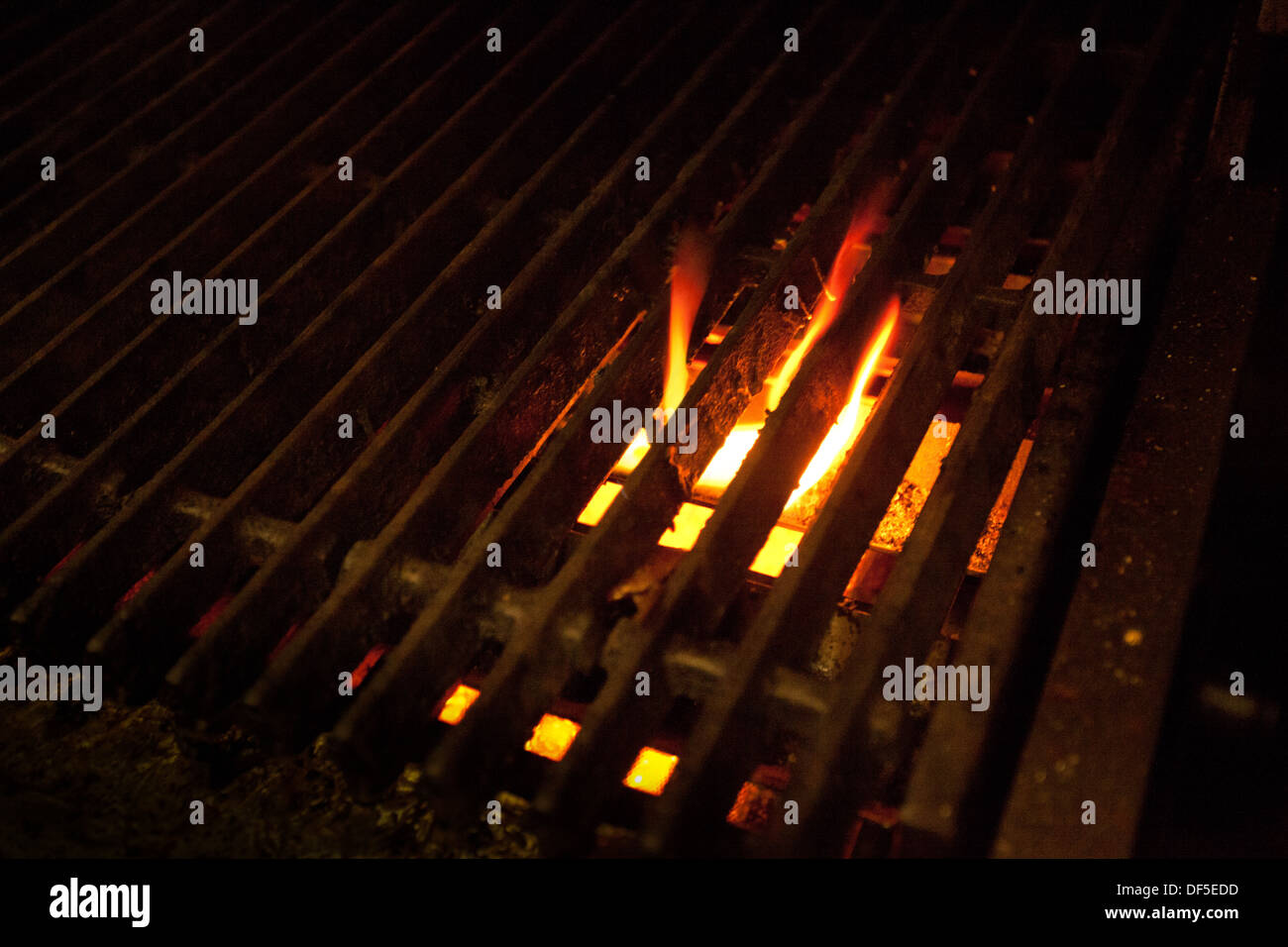 Fire in an old-fashioned open flame grill Stock Photo - Alamy