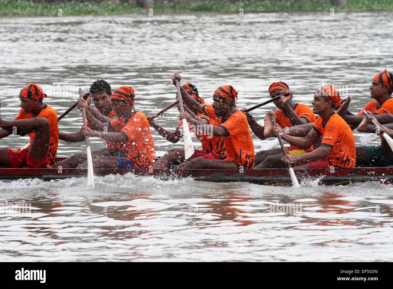 Bangladeshi men row a boat during a traditional boat race on the ...