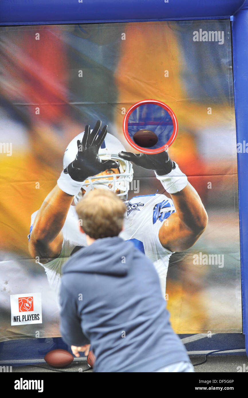 Regent Street, London, UK. 28th September 2013. A man throws a football ...