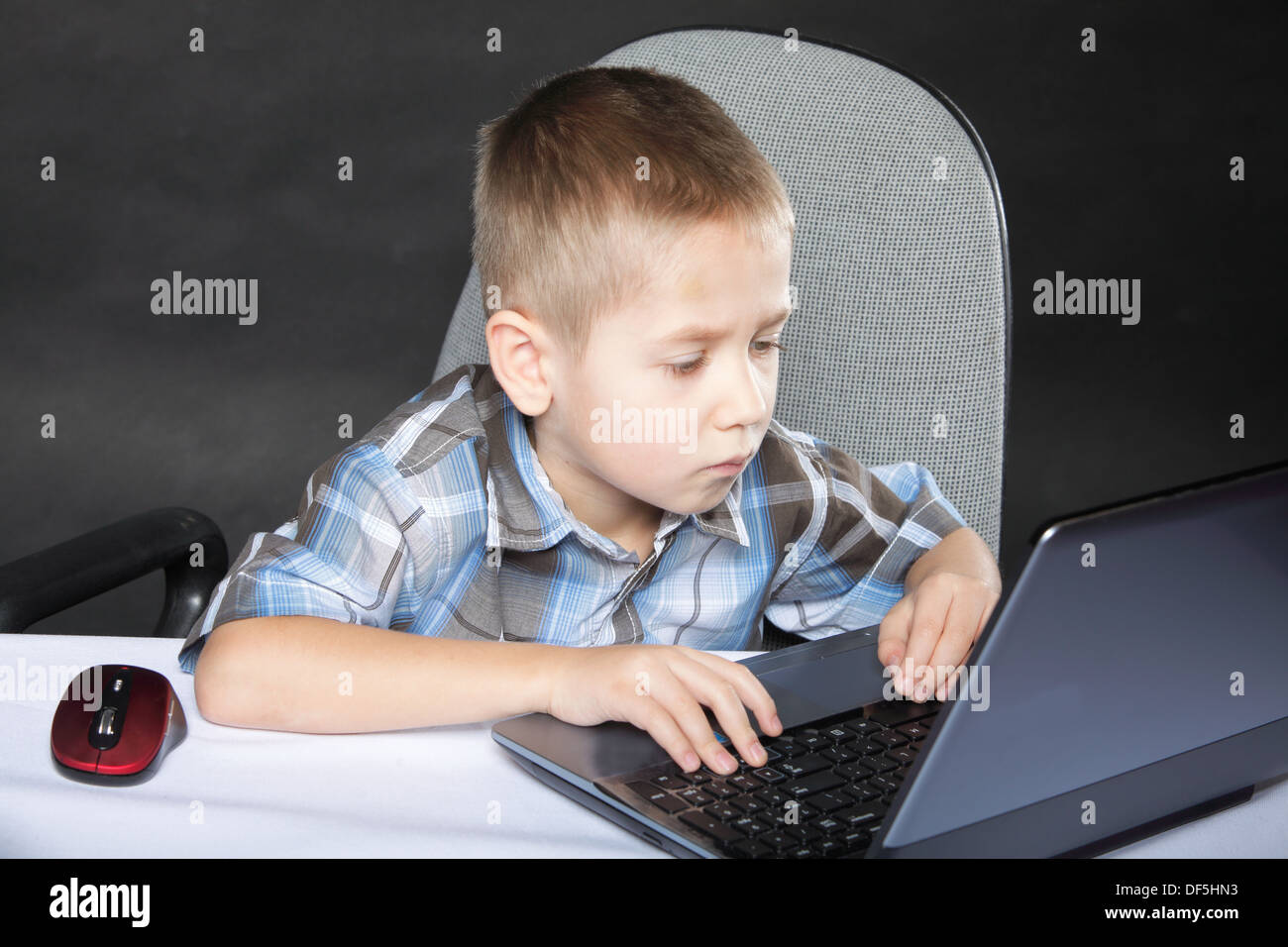 Computer addiction child boy with laptop notebook black background ...