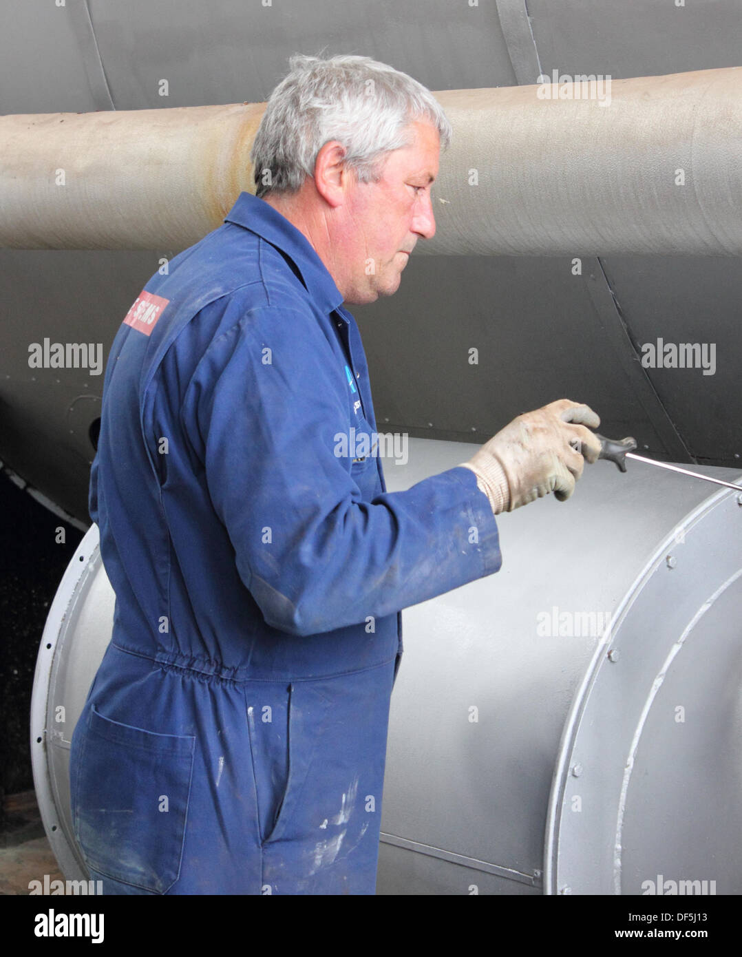Painting a large steam boiler after a refit Stock Photo - Alamy