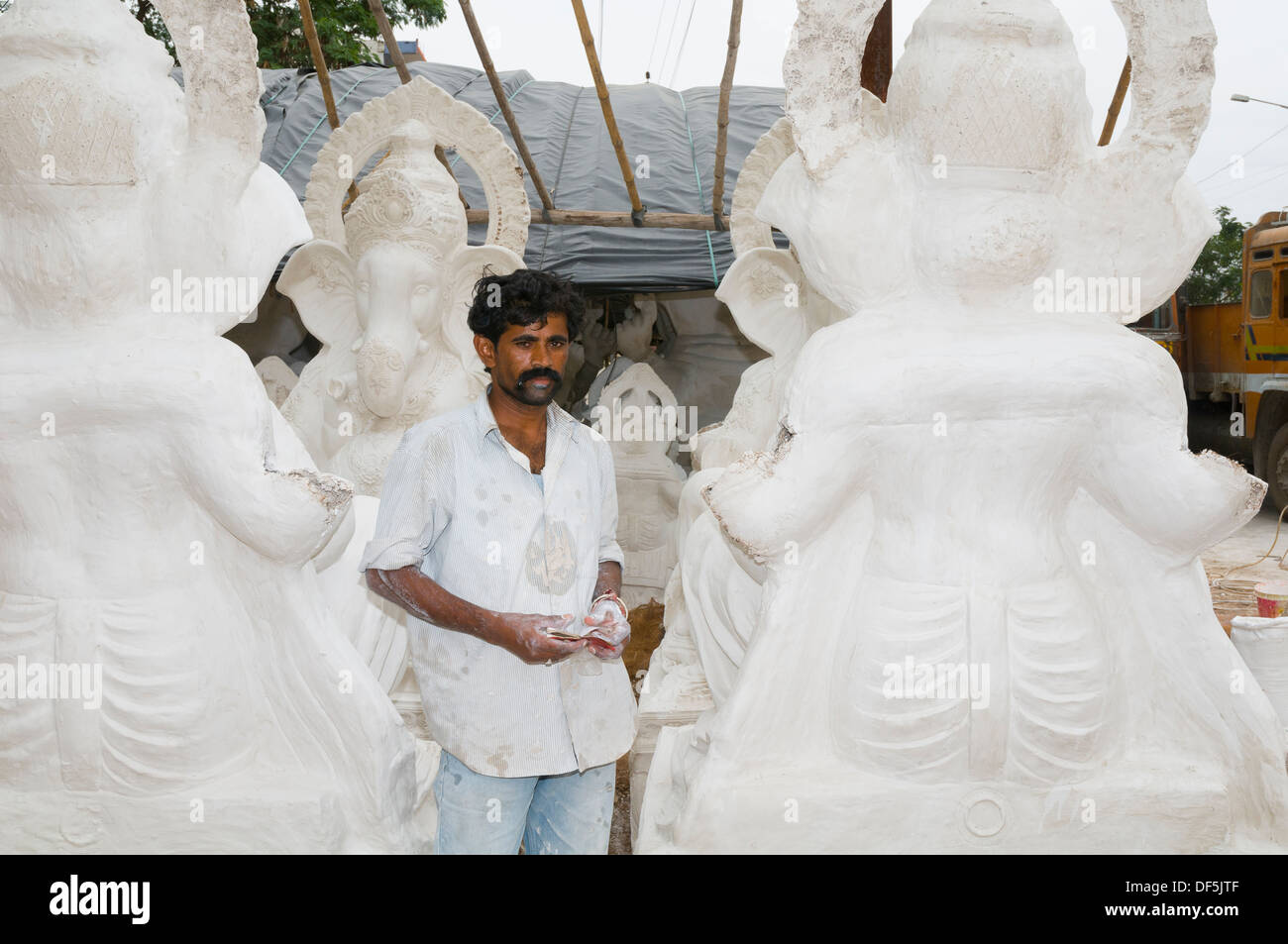 Workers in India making idols in makeshift factories on the side of the ...