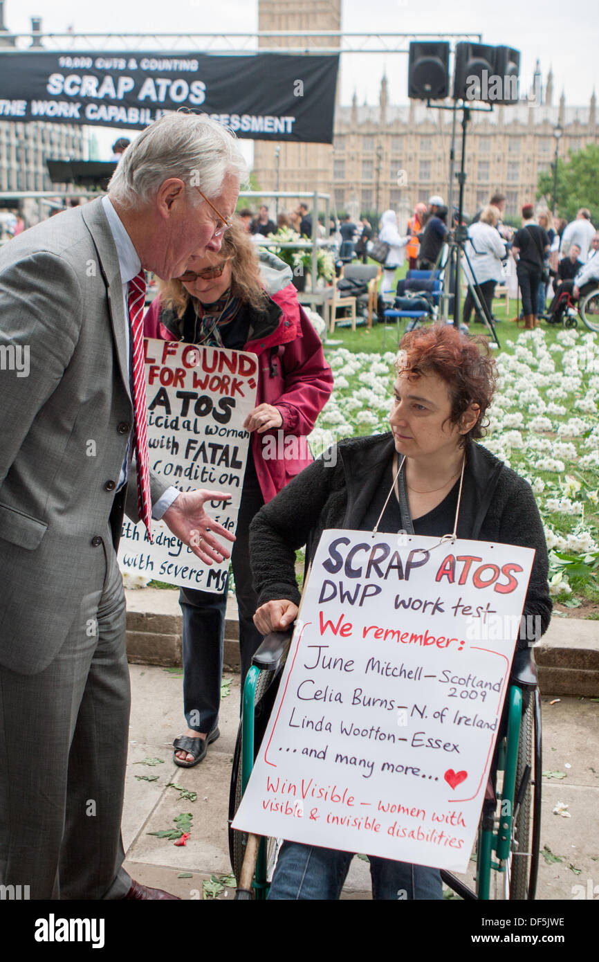 London, UK. 28th Sep, 2013. Michael Meacher MP speaks to woman with ...