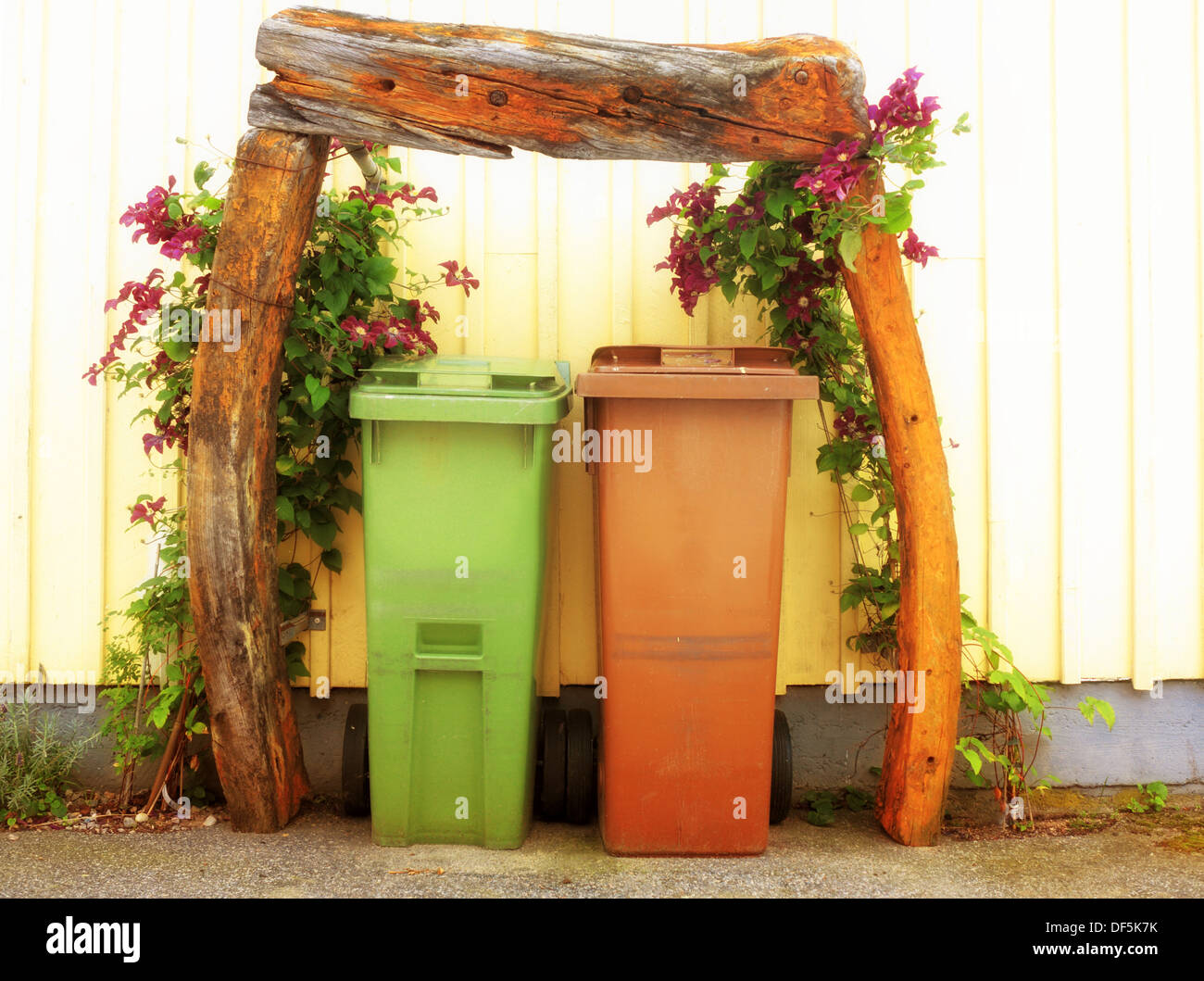 Two industrial trash garbage dust bins on the street flower decoration ...