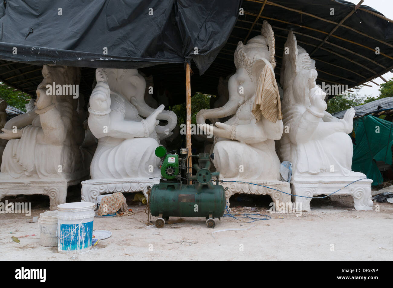 Workers in India making idols in makeshift factories on the side of the ...