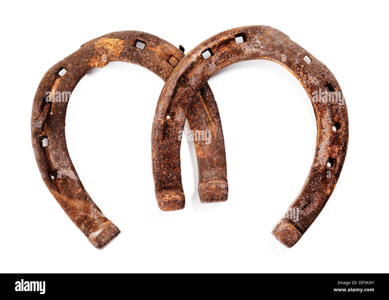 Old rusty and worn horseshoes isolated on white with natural shadows ...