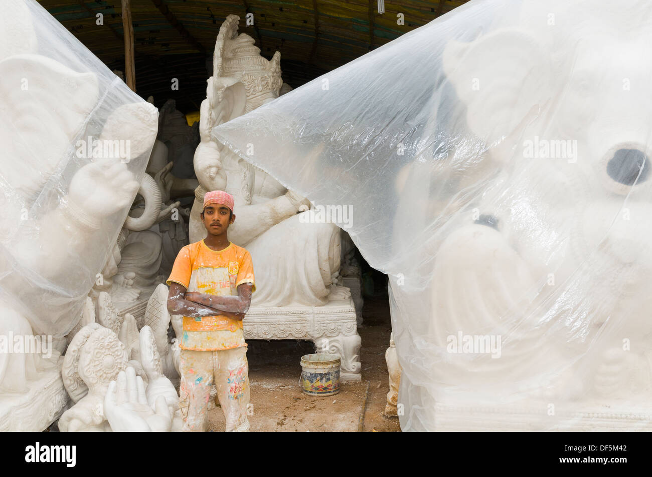 Workers in India making idols in makeshift factories on the side of the ...