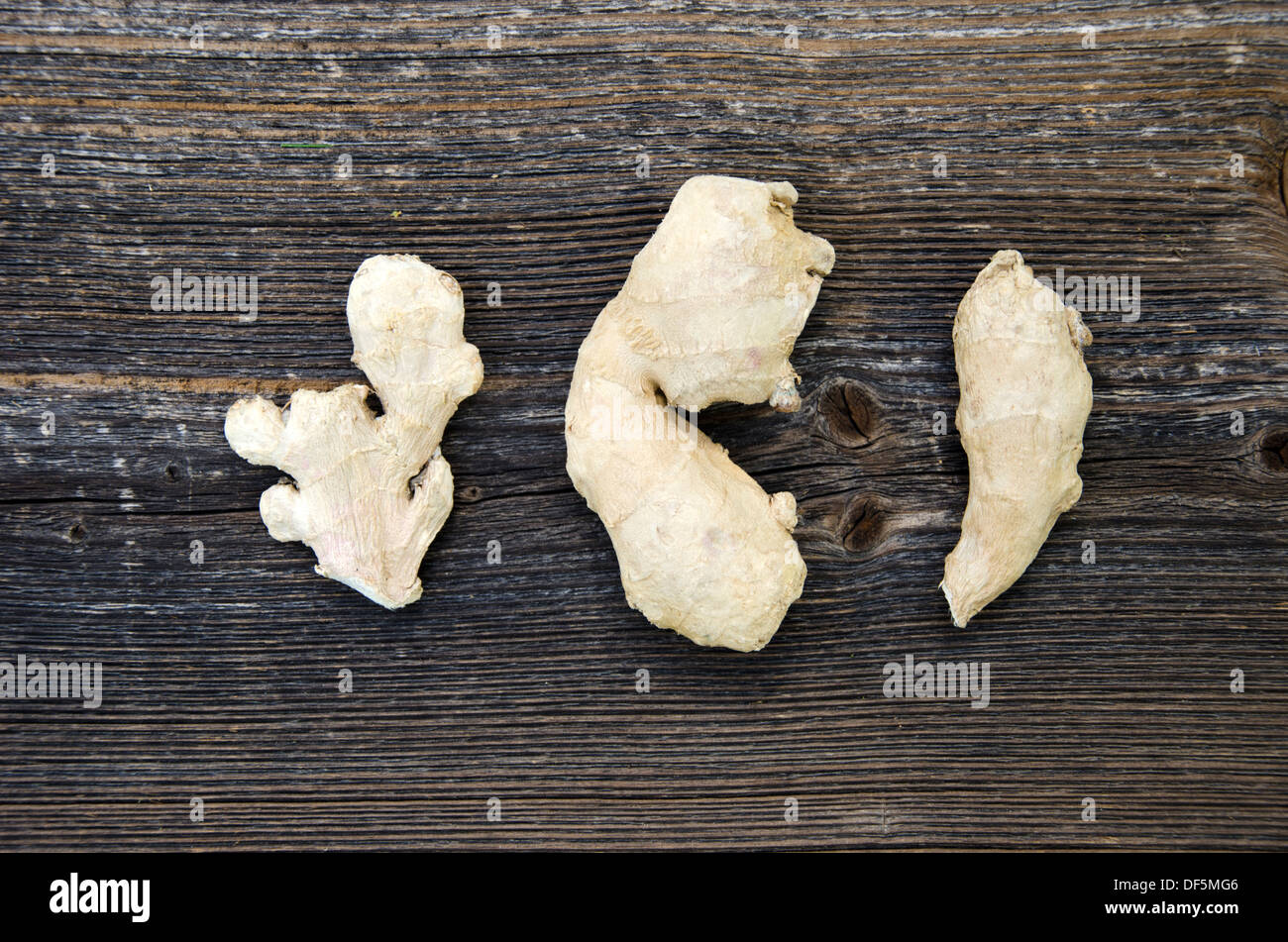 raw ginger vegetable on old wooden background Stock Photo - Alamy