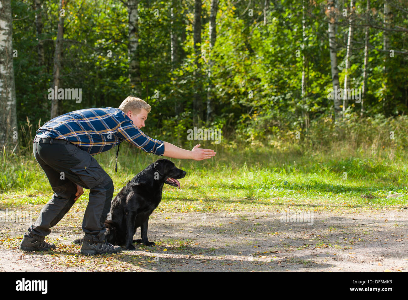 Man with black labrador hi-res stock photography and images - Alamy