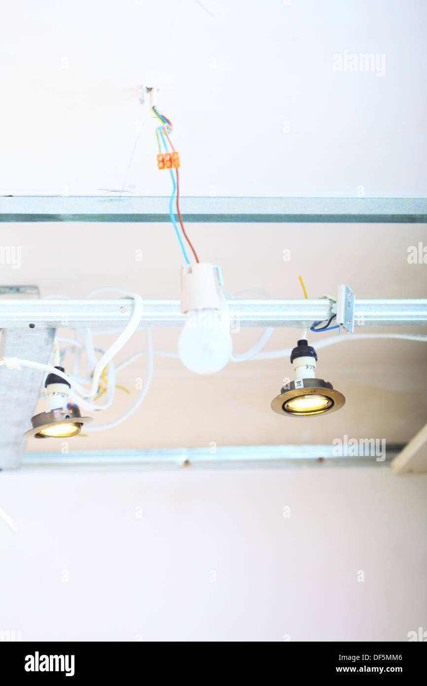 Electrical installation at construction site. Installing energy light ...