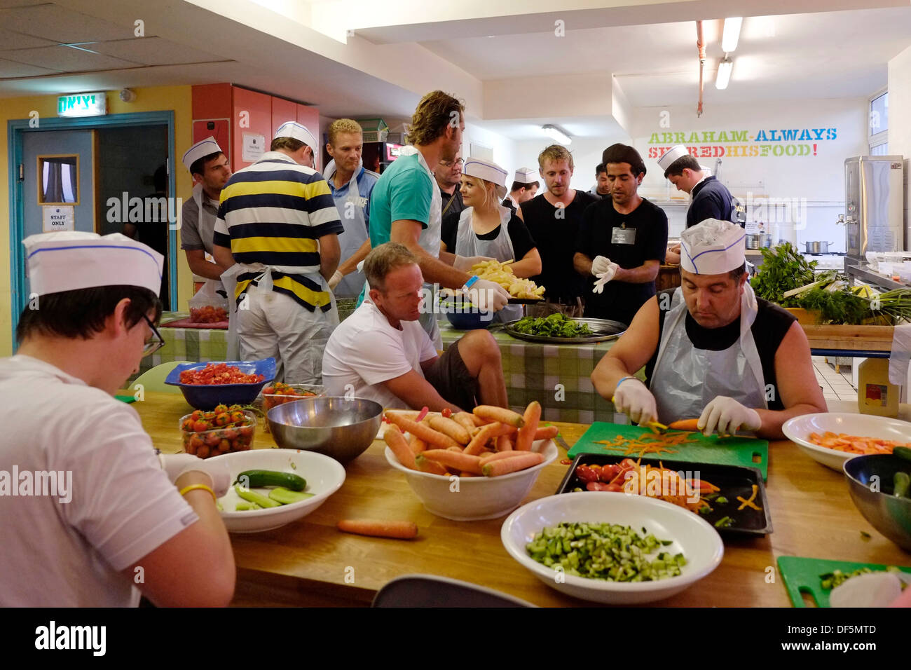 Tourists and staff preparing Friday night dinner together in Abraham ...