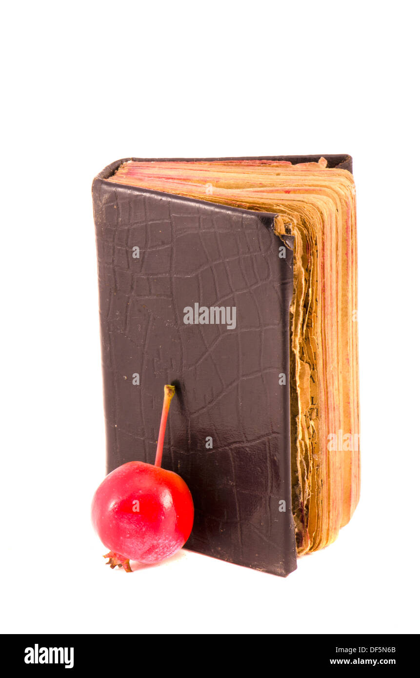 old used christianity prayer book Bible with red apple isolated on ...