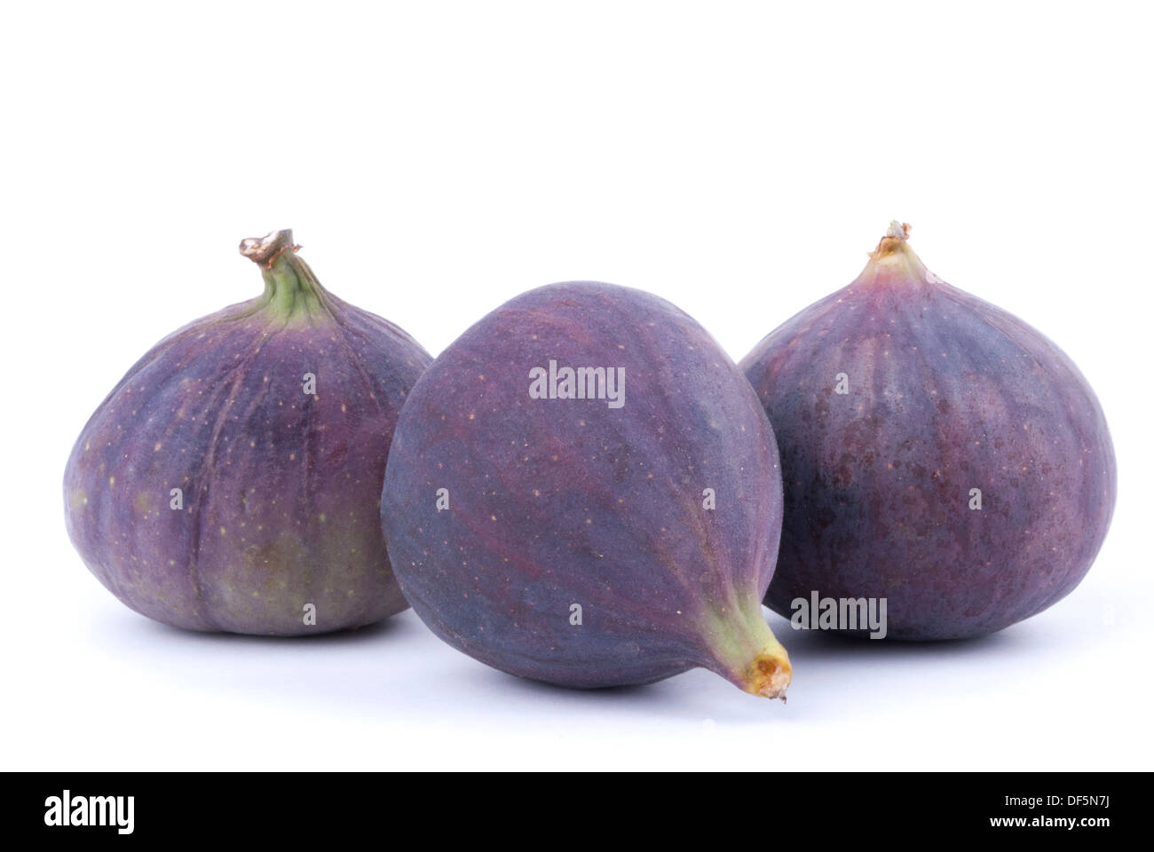 Three figs on a white background Stock Photo - Alamy