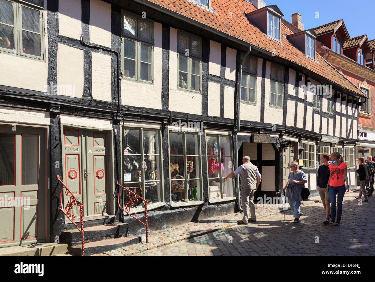 Shop in old timbered building with tourists in best kept medieval ...