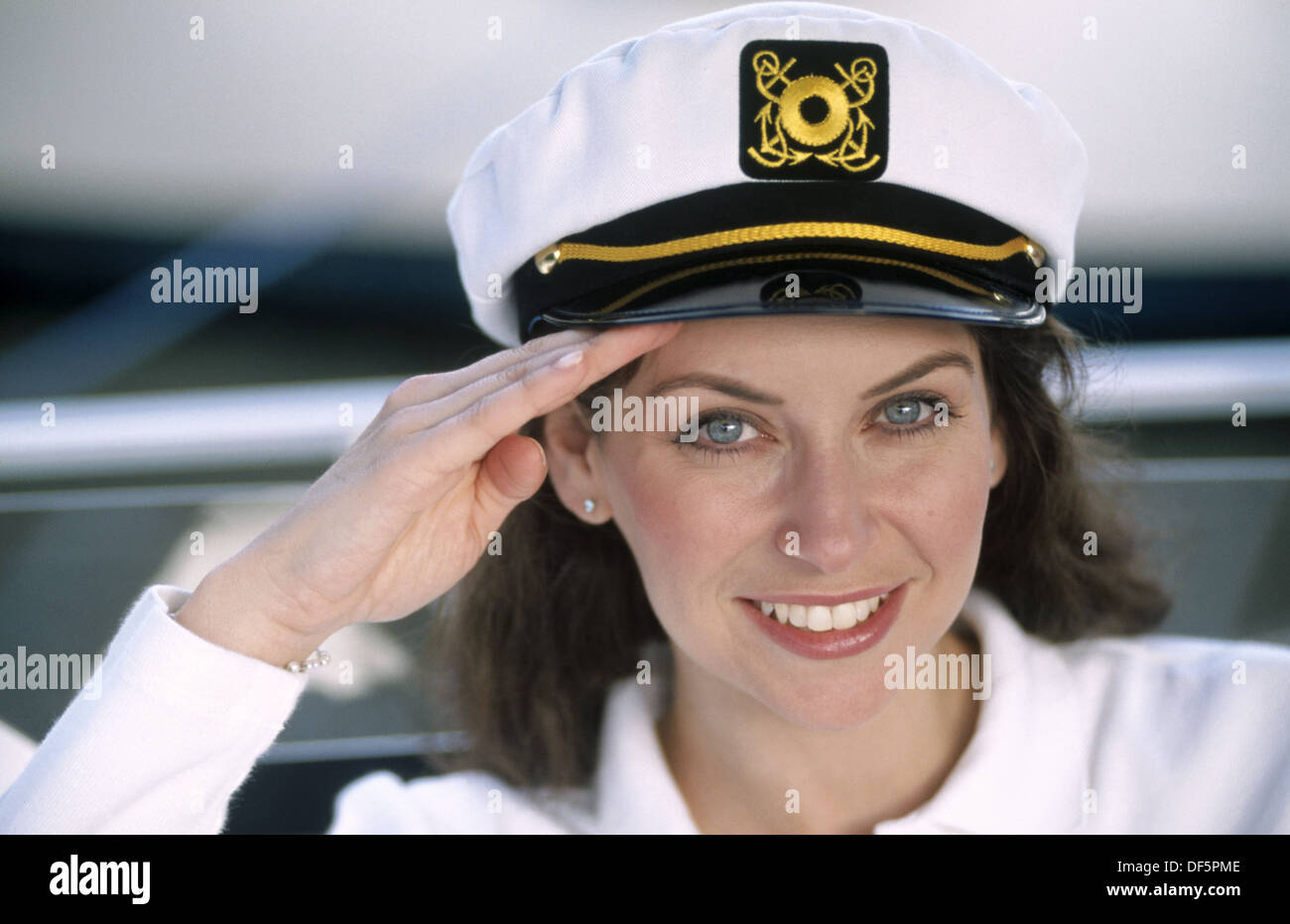 girl in a boating cap saluting Stock Photo - Alamy