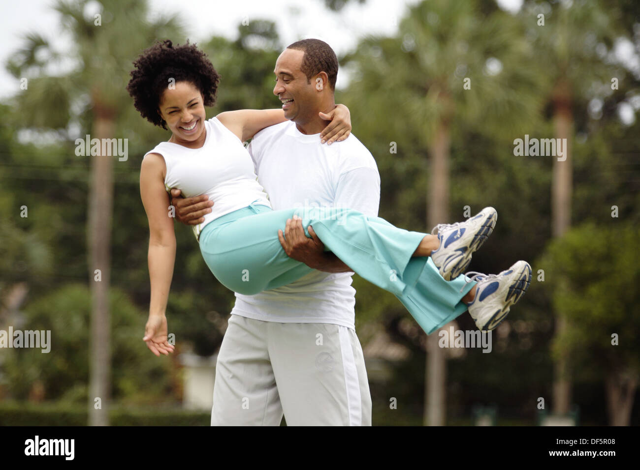 Man carrying his girlfriend Stock Photo - Alamy
