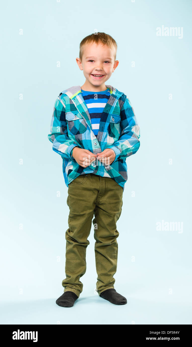 Playful little boy on studio, light blue background Stock Photo - Alamy