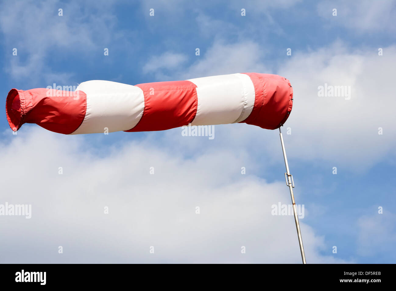 Wind indication with a red and white windsock Stock Photo - Alamy
