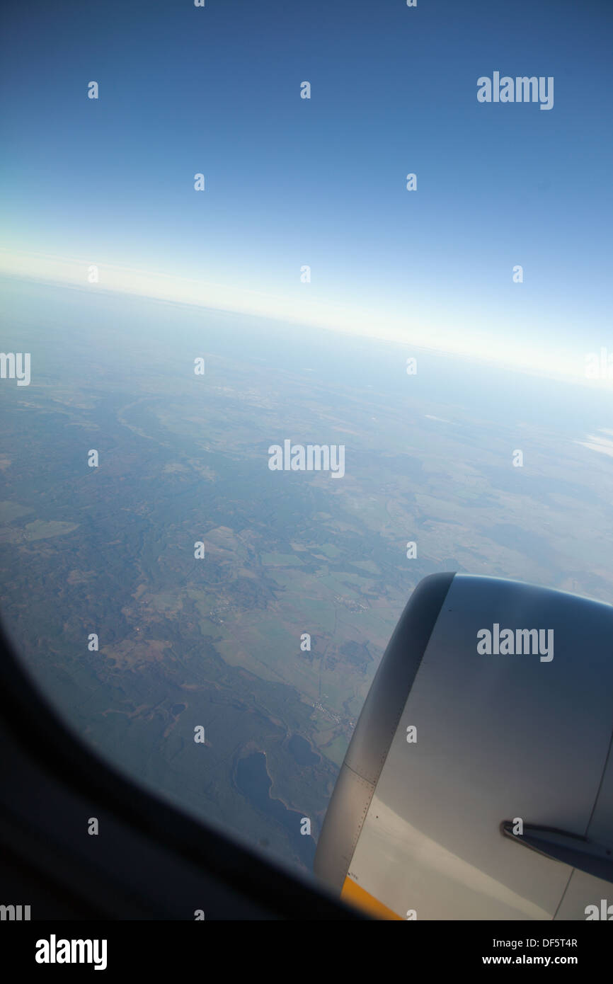 Airplane in the blue sky engine and wings white clouds Stock Photo - Alamy